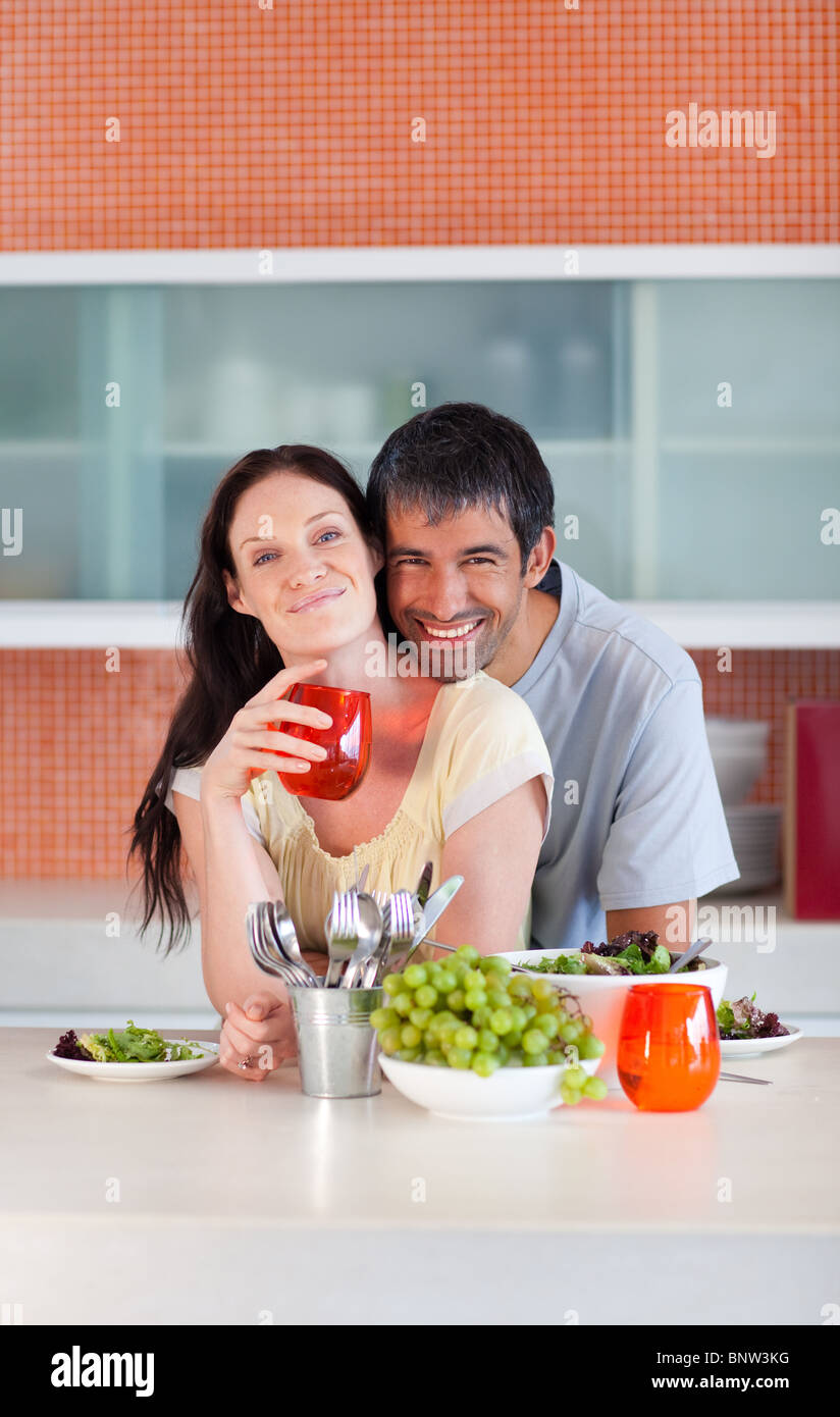 Lovers eating in the kitchen Stock Photo - Alamy