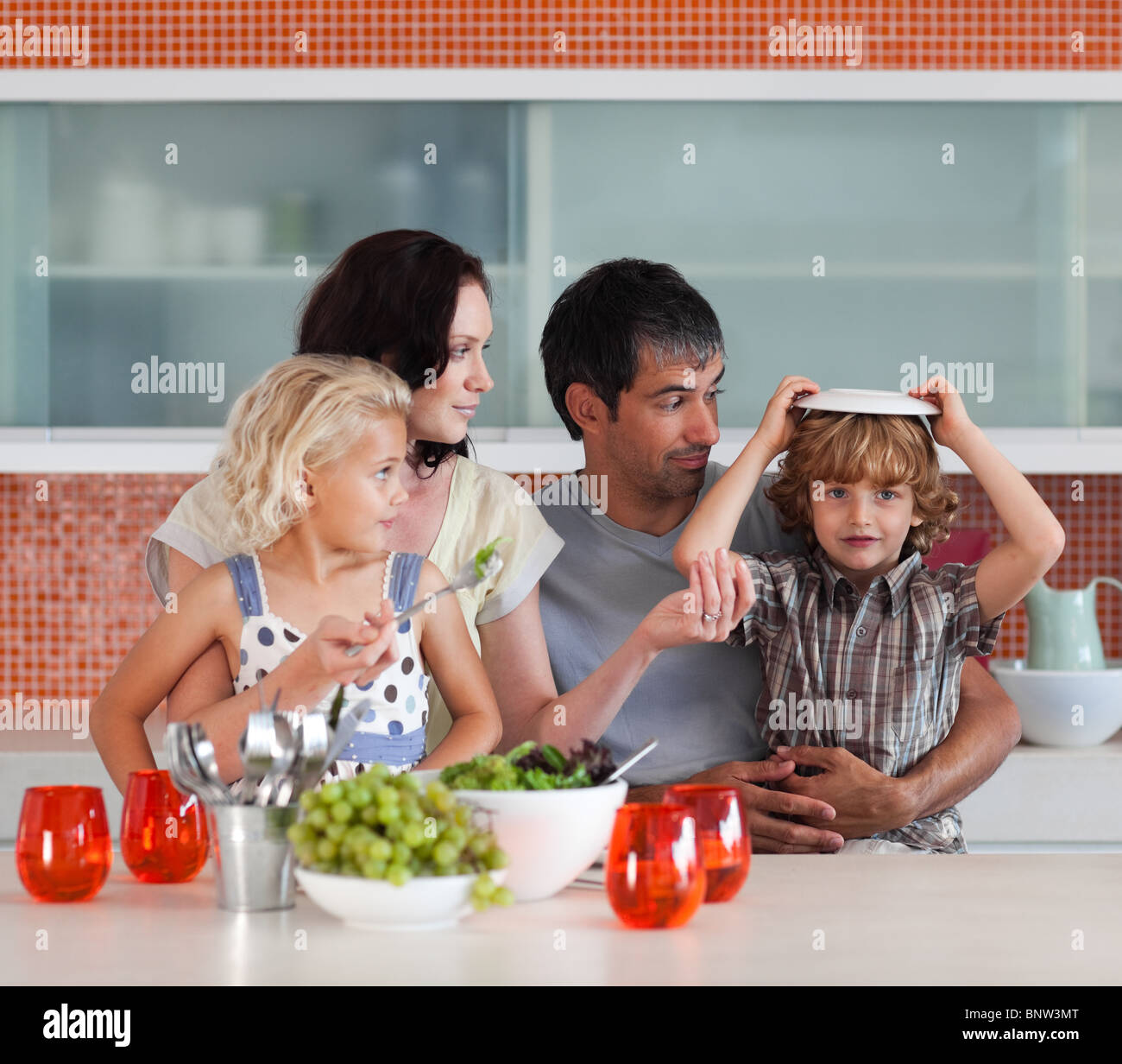 Happy family eating in a kitchen Stock Photo - Alamy