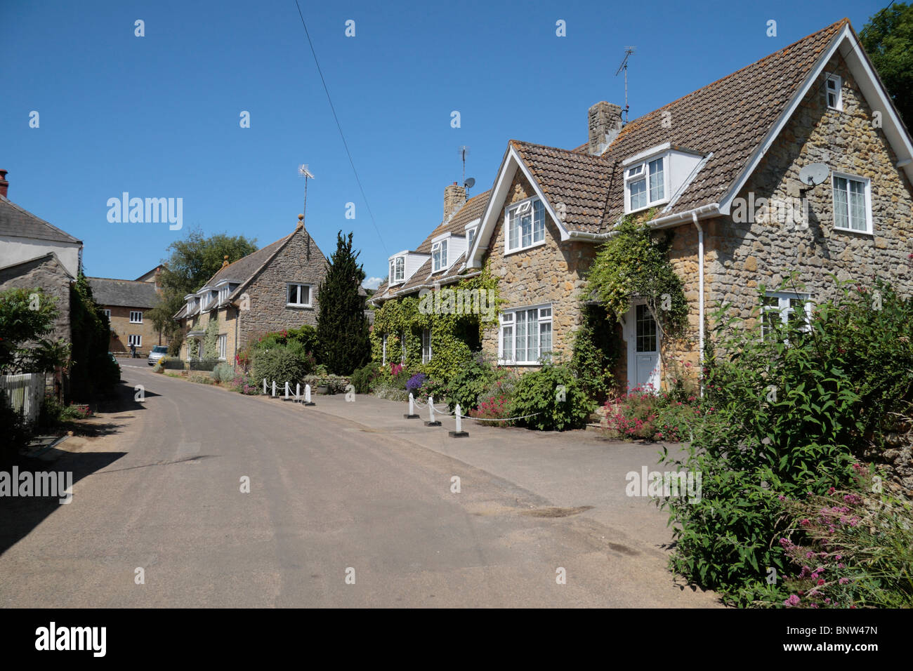 View along the picturesque high street in the village of Shipton Gorge ...