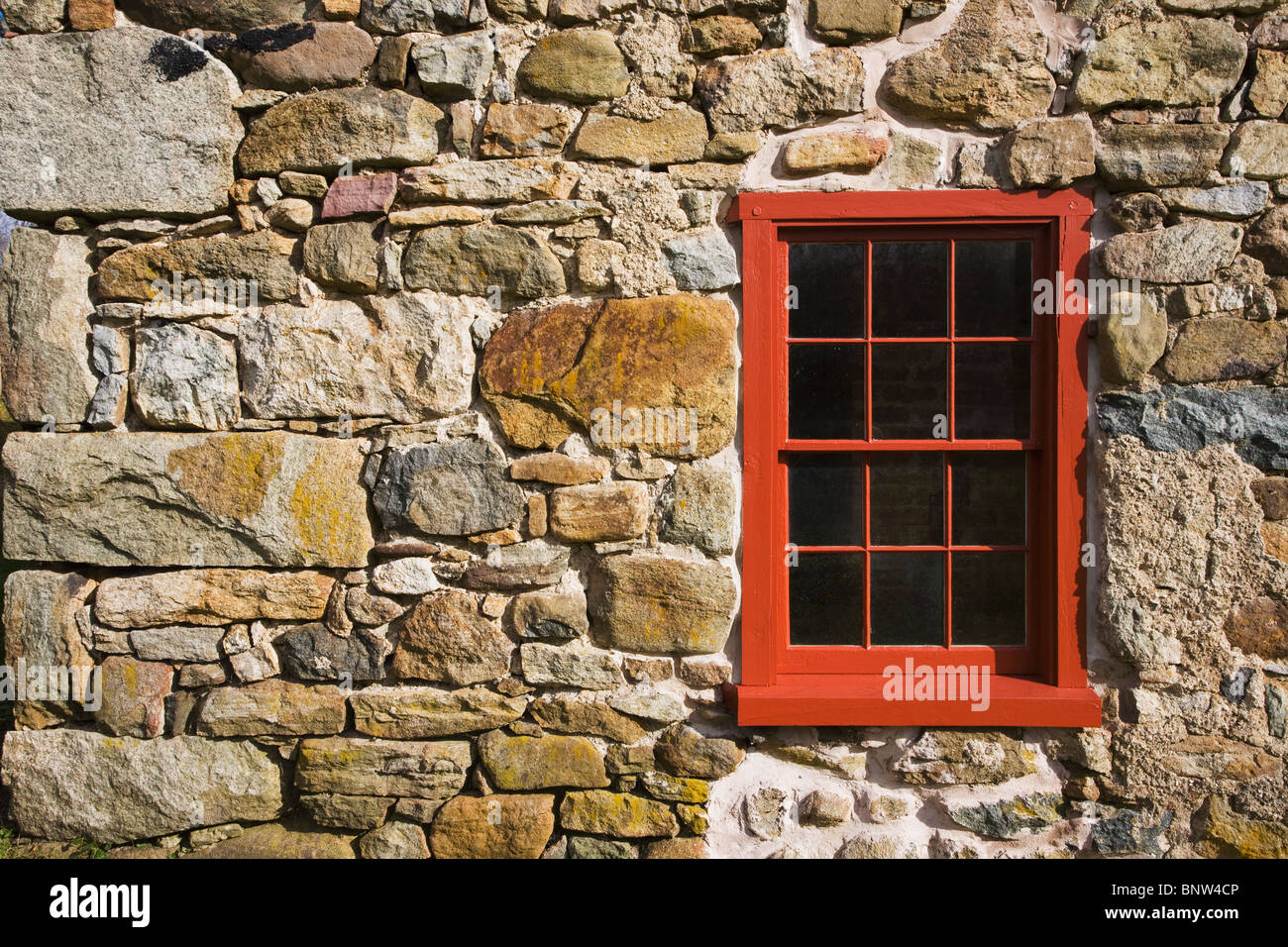 Window on stone barn wall Stock Photo - Alamy