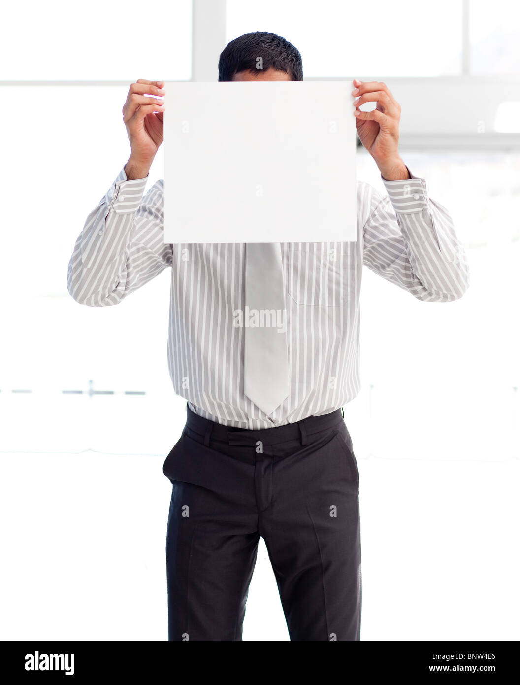 Businessman showing a white card covering his face Stock Photo - Alamy