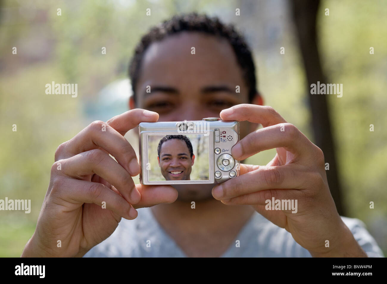 Man taking self portrait with digital camera Stock Photo - Alamy