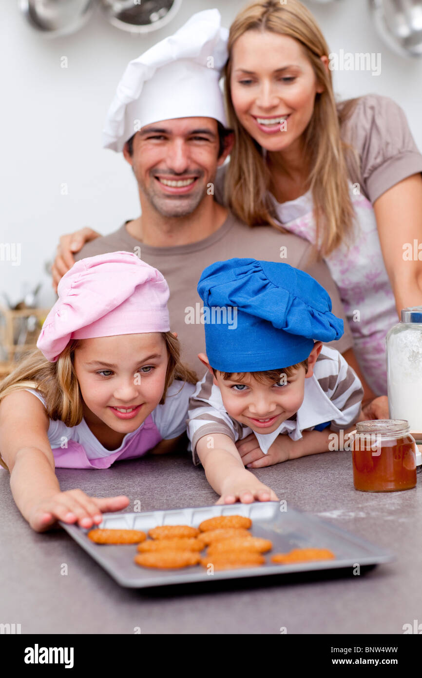 Family eating cookies after baking Stock Photo - Alamy