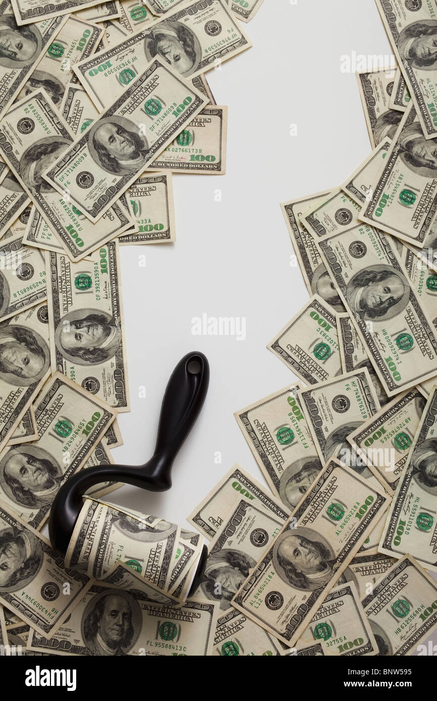 Lint roller picking up money Stock Photo - Alamy