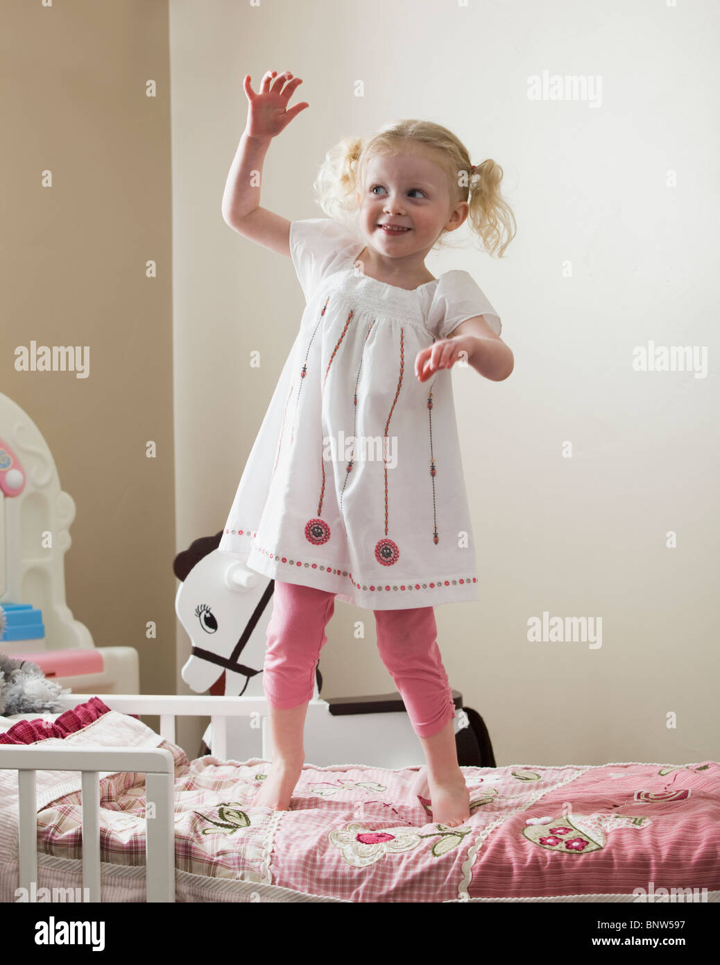 Young girl dancing on her bed Stock Photo - Alamy