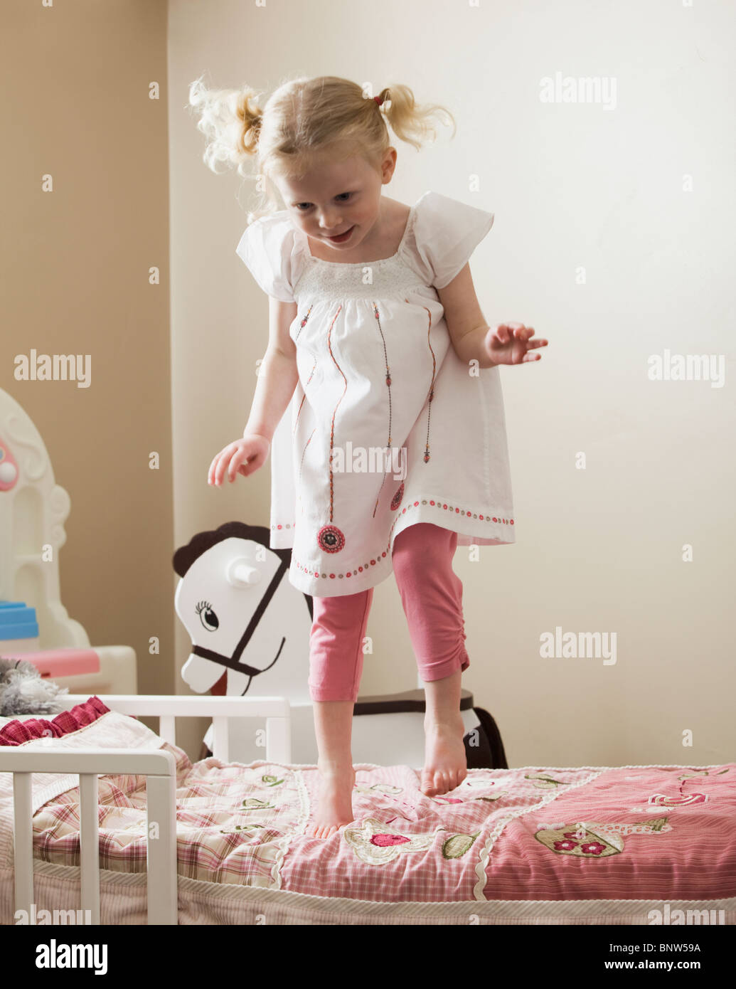 Young girl dancing on her bed Stock Photo - Alamy