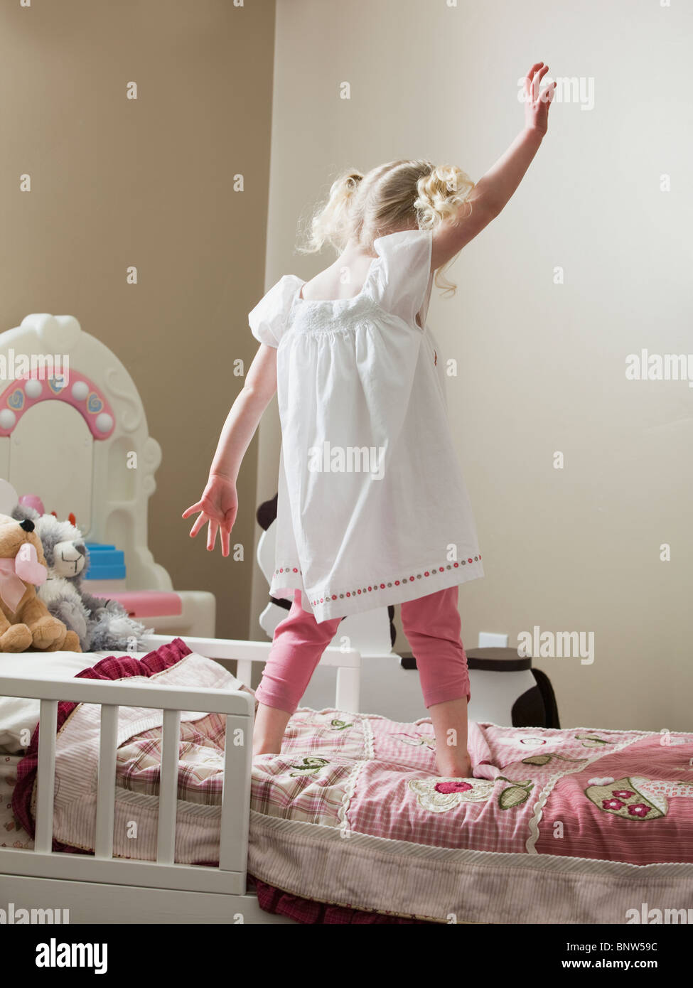 Young girl dancing on her bed Stock Photo - Alamy