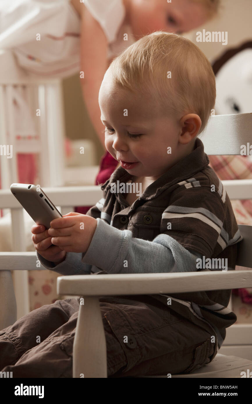Toddler playing with electronic device hi-res stock photography and ...
