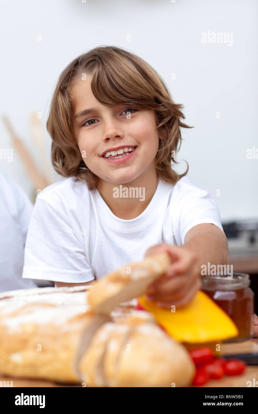 Smiling child eating bread Stock Photo - Alamy