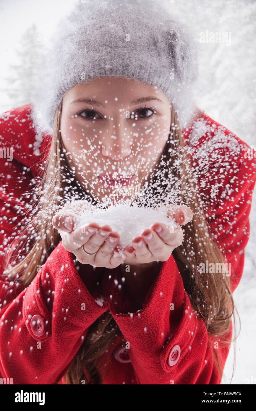 Woman blowing snow off her hands Stock Photo - Alamy