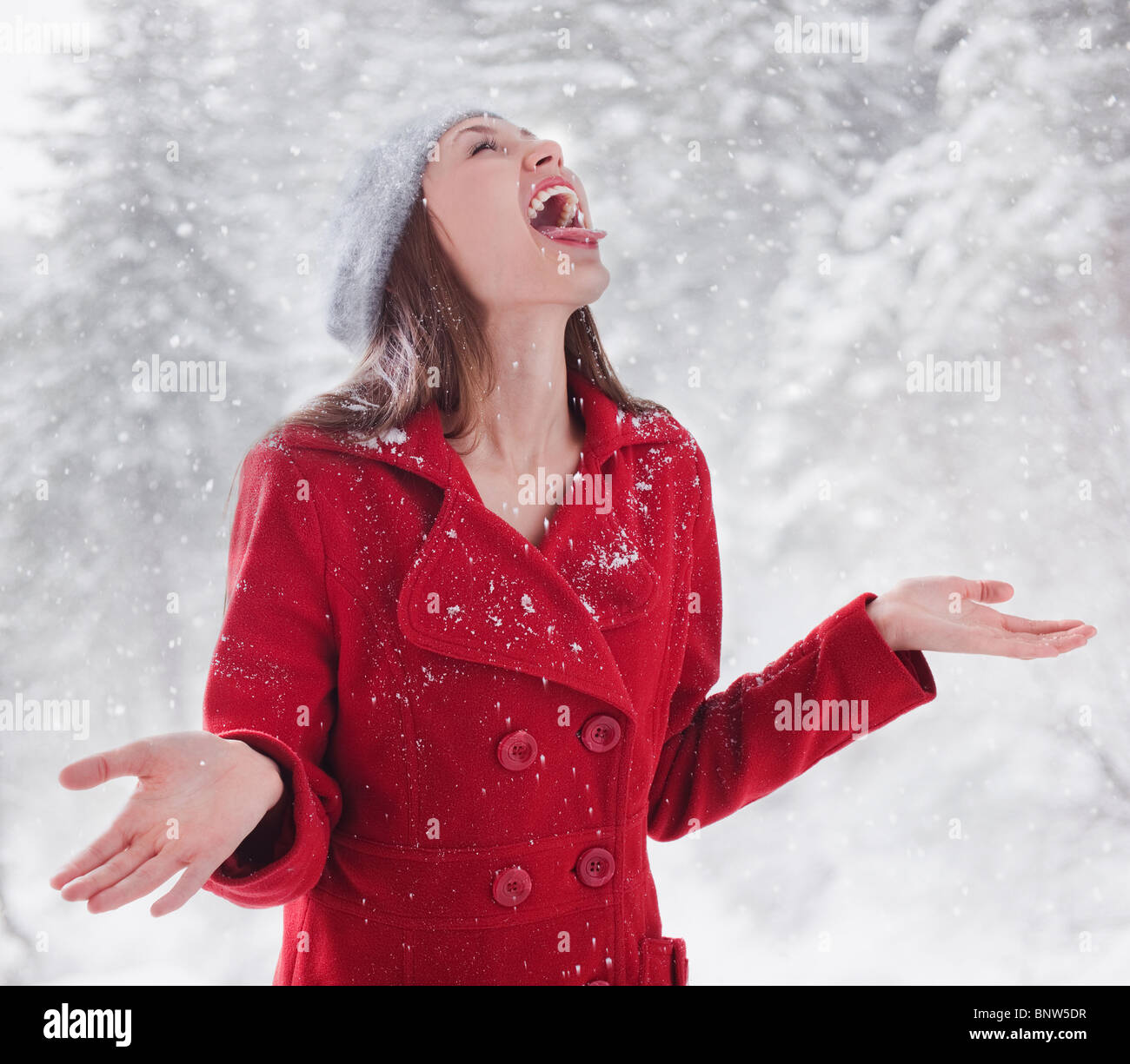 Woman trying to catch snow on her tongue Stock Photo - Alamy