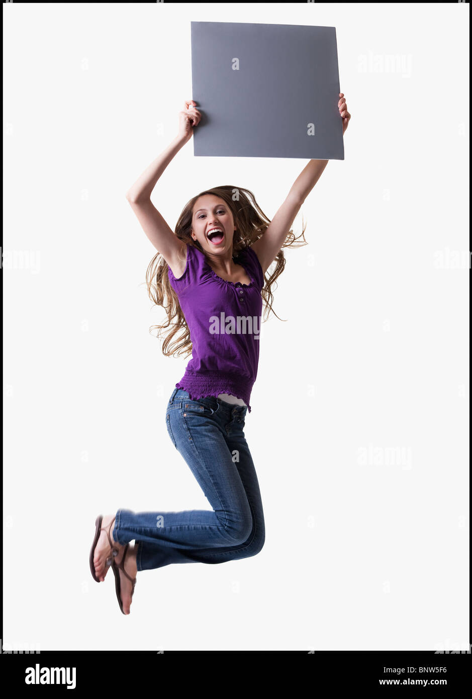 Teenage girl jumping for joy Stock Photo - Alamy