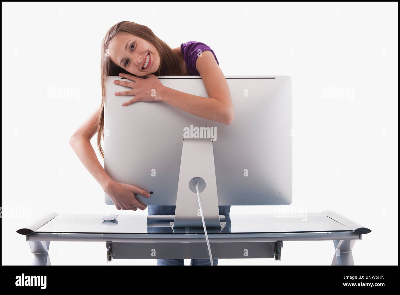Happy woman hugging a computer monitor Stock Photo - Alamy