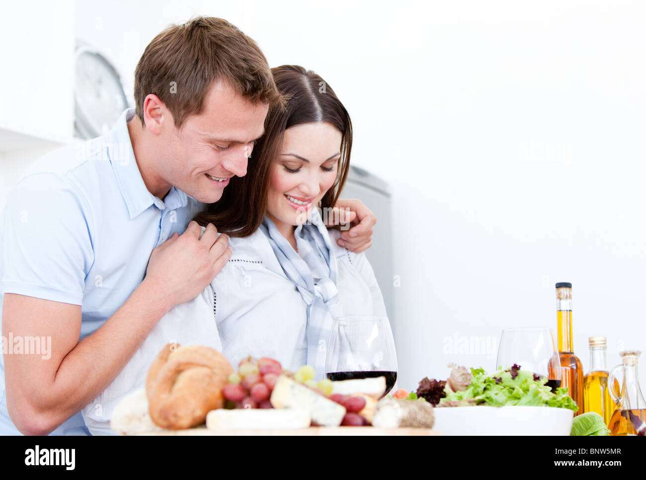 Portrait of Cute couple preparing a meal Stock Photo - Alamy