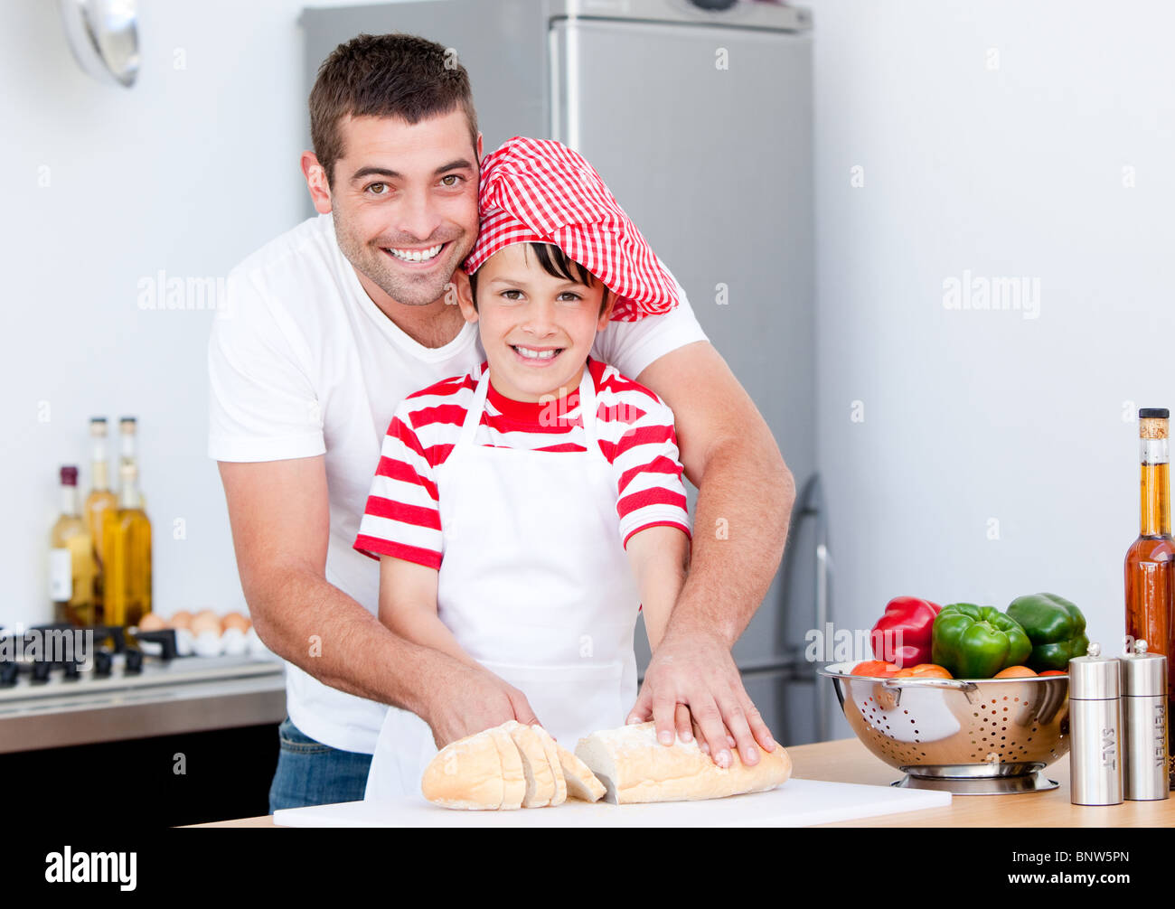 Portrait of a smiling father and his son preparing a meal Stock Photo - Alamy