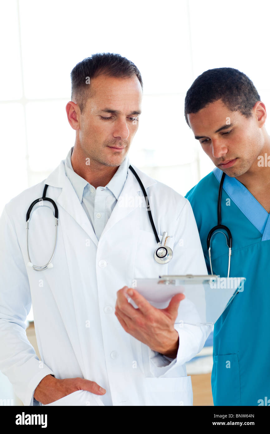 Two attractive doctors talking about a patient Stock Photo - Alamy