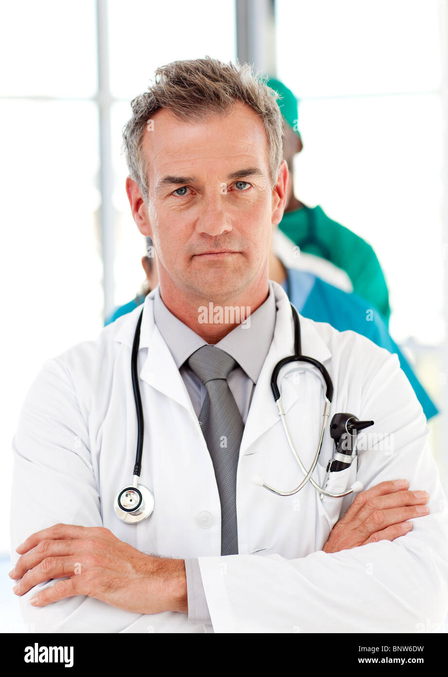 Senior doctor leading a medical team Stock Photo - Alamy