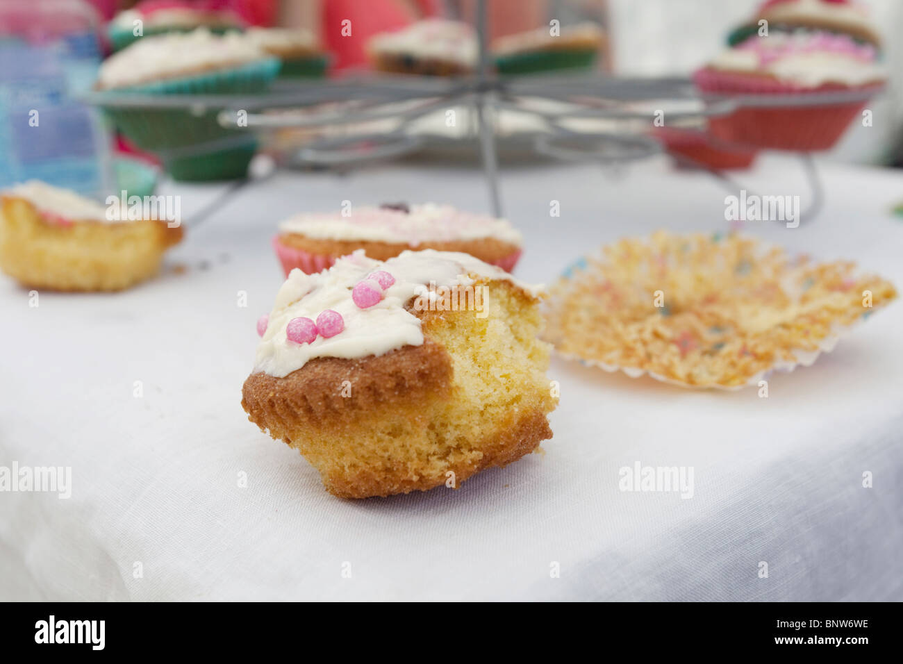 half eaten cupcake on table Stock Photo - Alamy