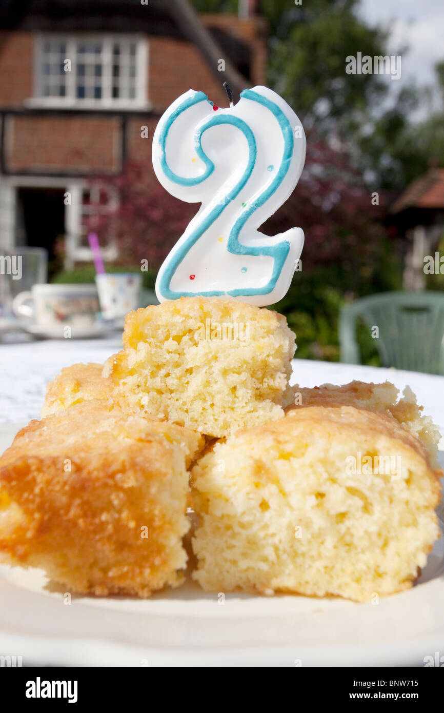 lemon cake with number two candle on top in garden Stock Photo - Alamy