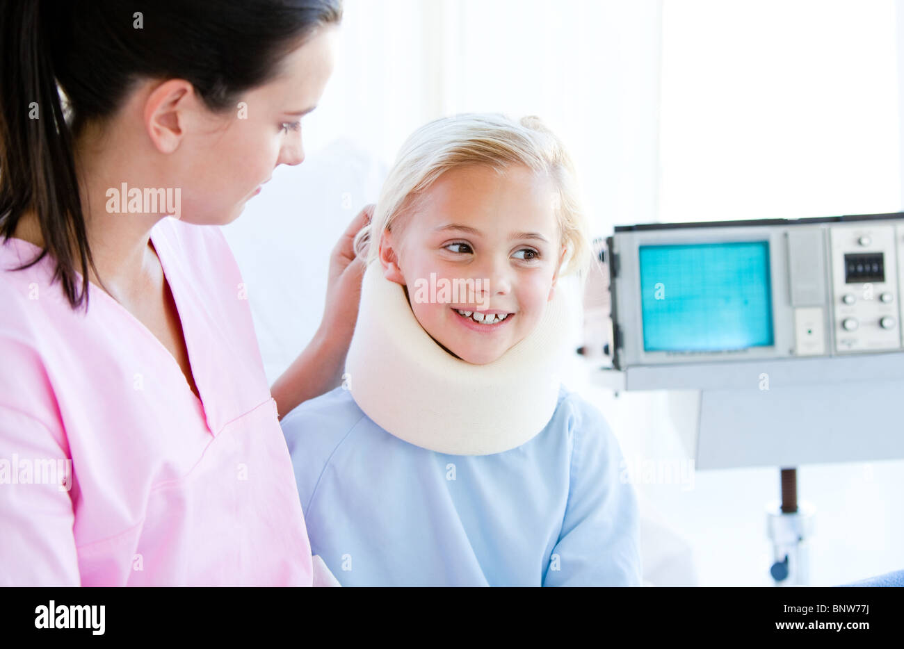 Adorable little girl with a neck brace sitting with her nurse Stock ...
