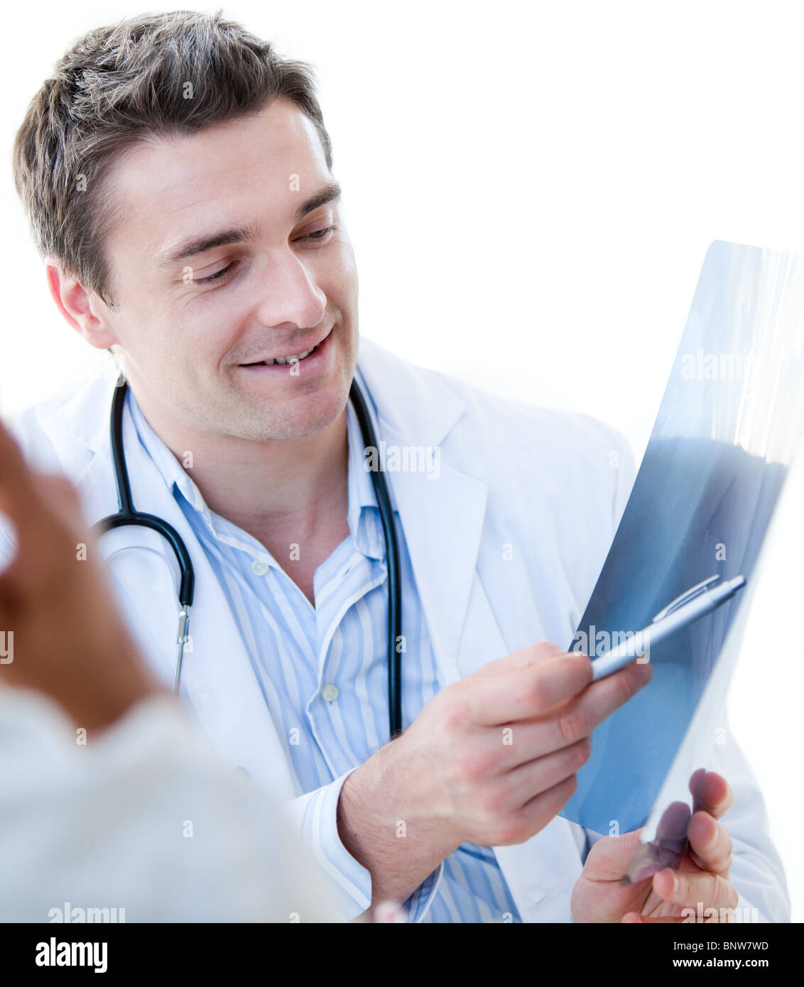 Handsome male doctor looking at a X-ray Stock Photo - Alamy