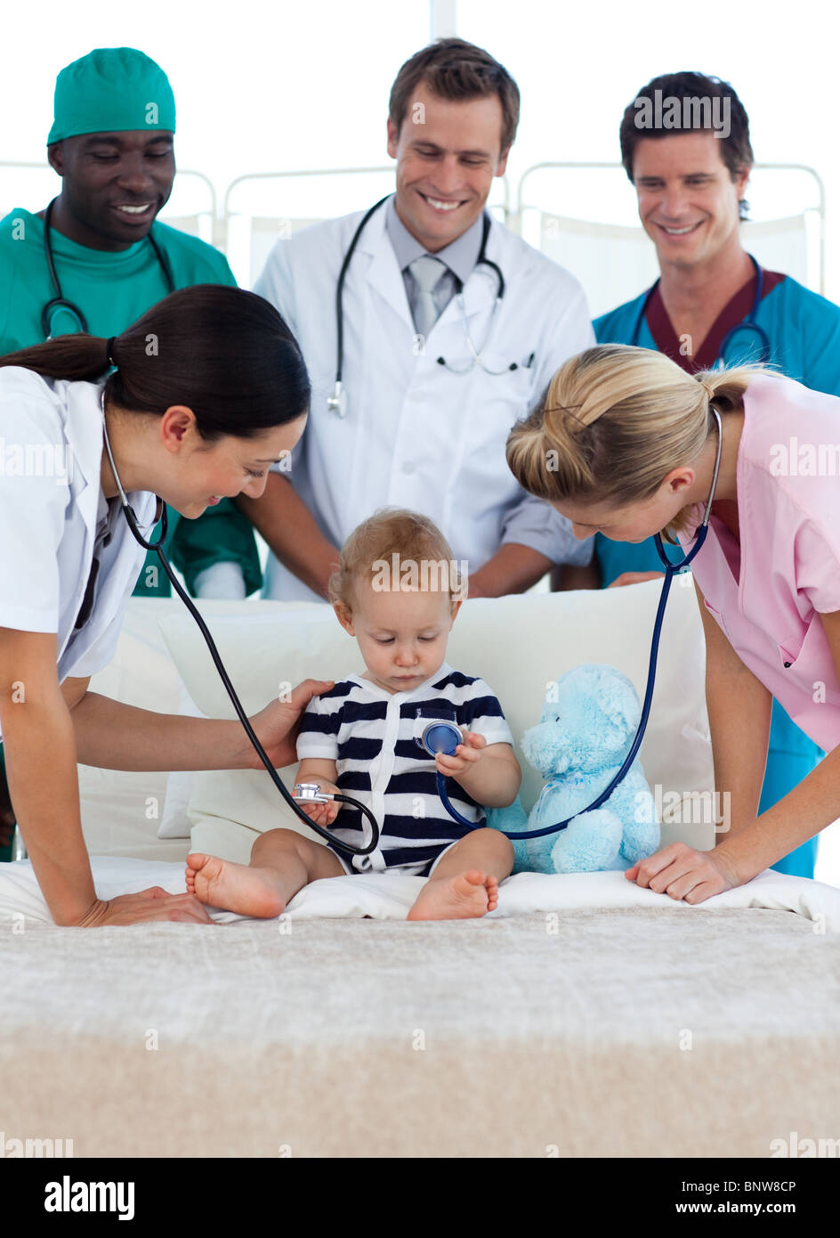 Little baby with a medical team Stock Photo - Alamy