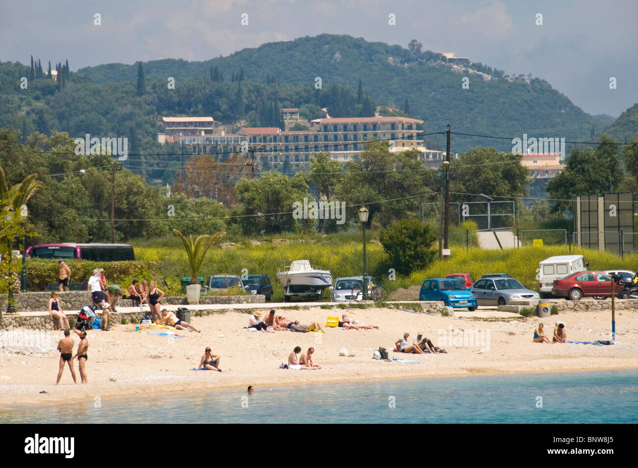 Corfu beach. Tourists relaxing on sandy beach at Paleokastritsa on the ...