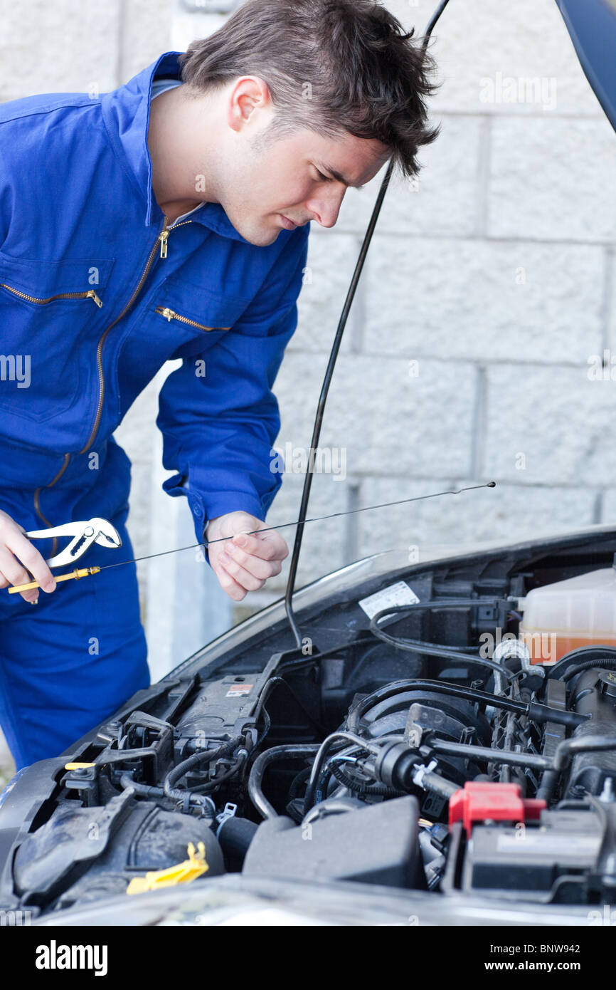 Handsome man repairing a car Stock Photo - Alamy