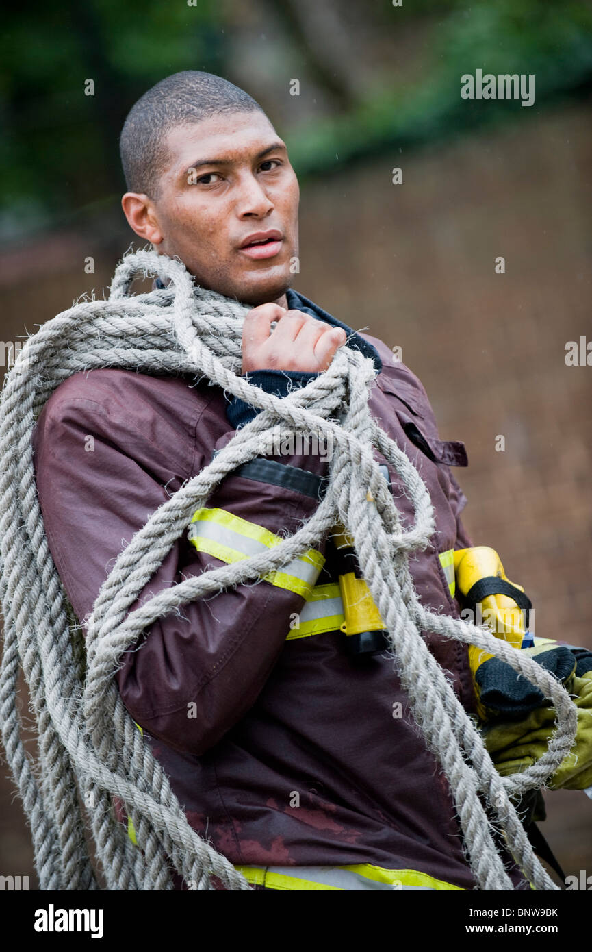 Members of the London Fire Service, some in breathing apparatus, go ...