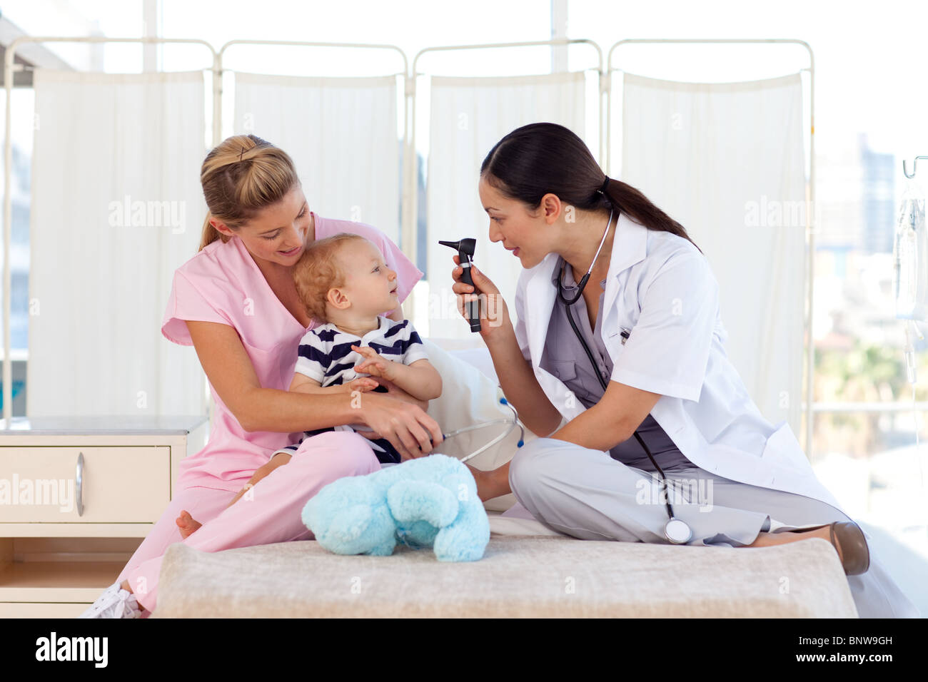 Young doctors attending to a baby Stock Photo - Alamy
