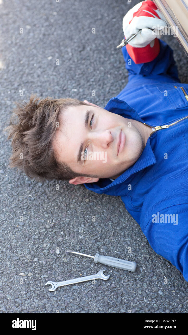 Portrait of a handsome man repairing a car Stock Photo - Alamy