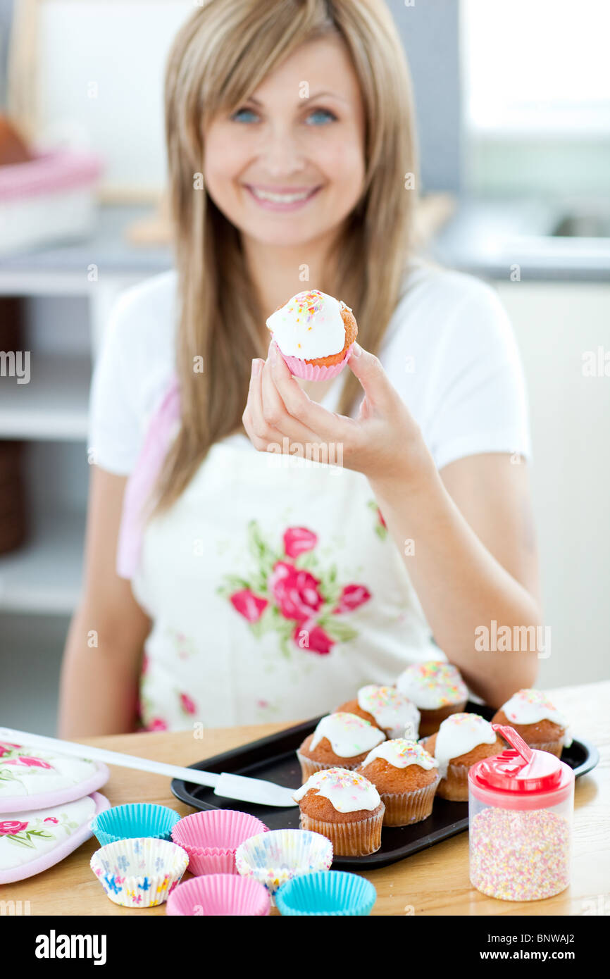 Young woman holding a cake in the kitchen Stock Photo - Alamy