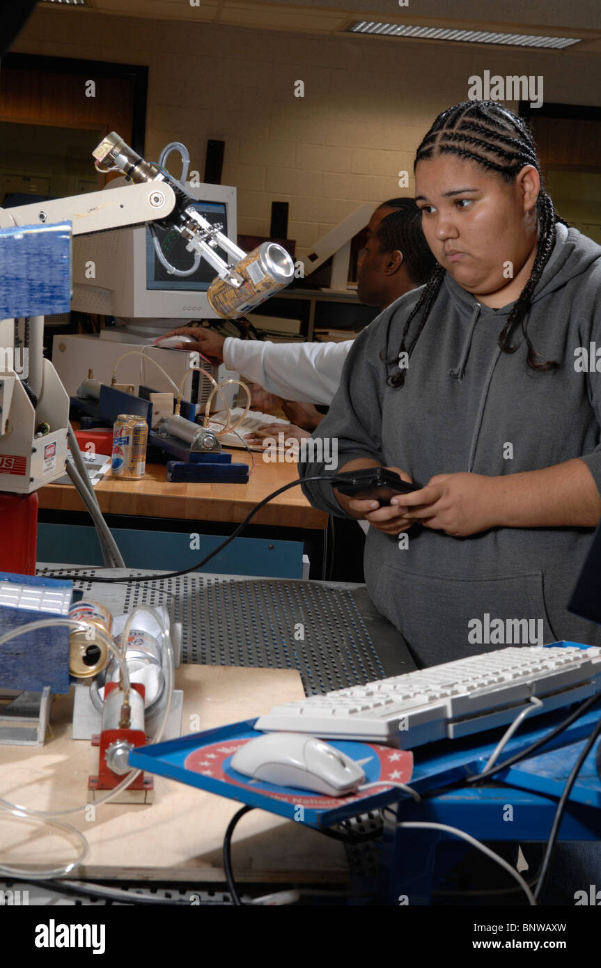 Hispanic female student at Carver Magnet High School operates a student ...