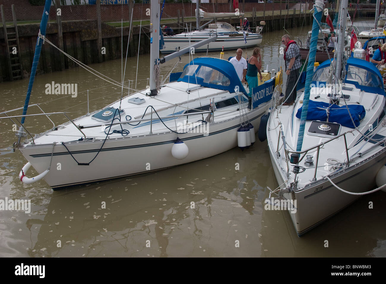 tied double berthed sailing boat sailors talking Stock Photo - Alamy