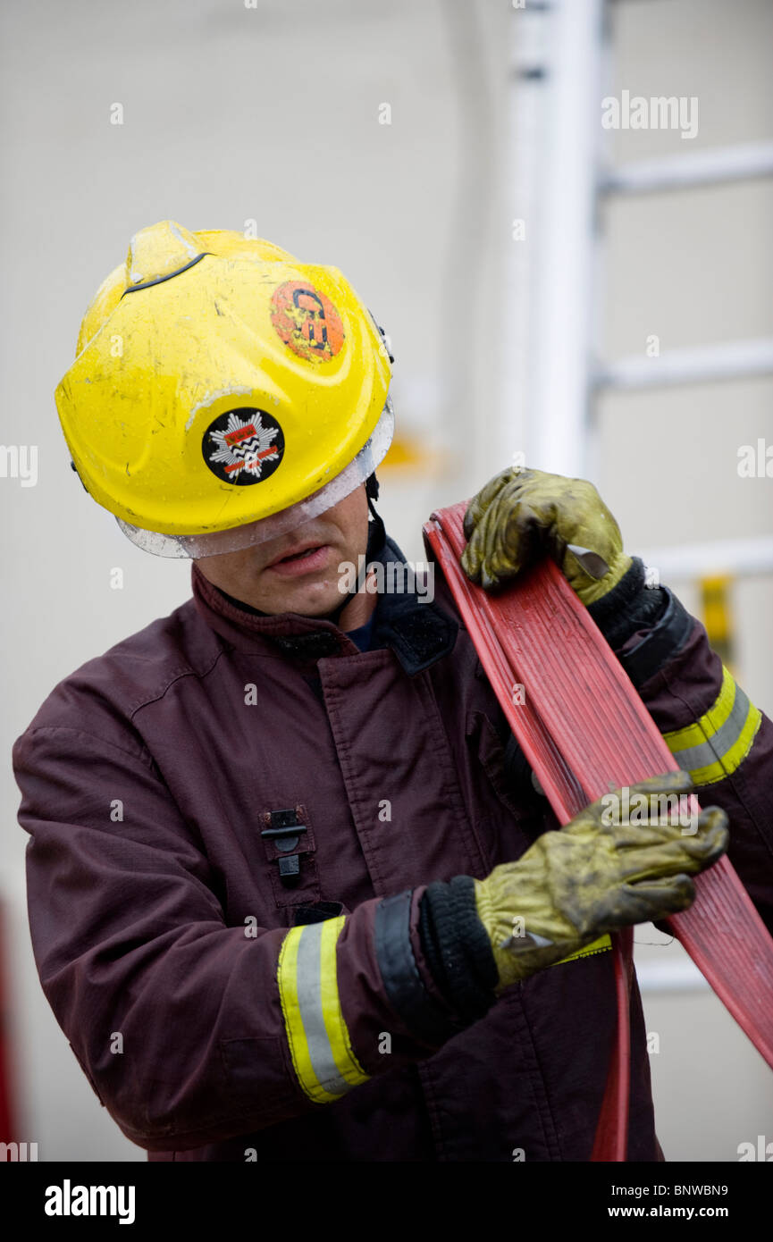 Members of the London Fire Service, some in breathing apparatus, go ...