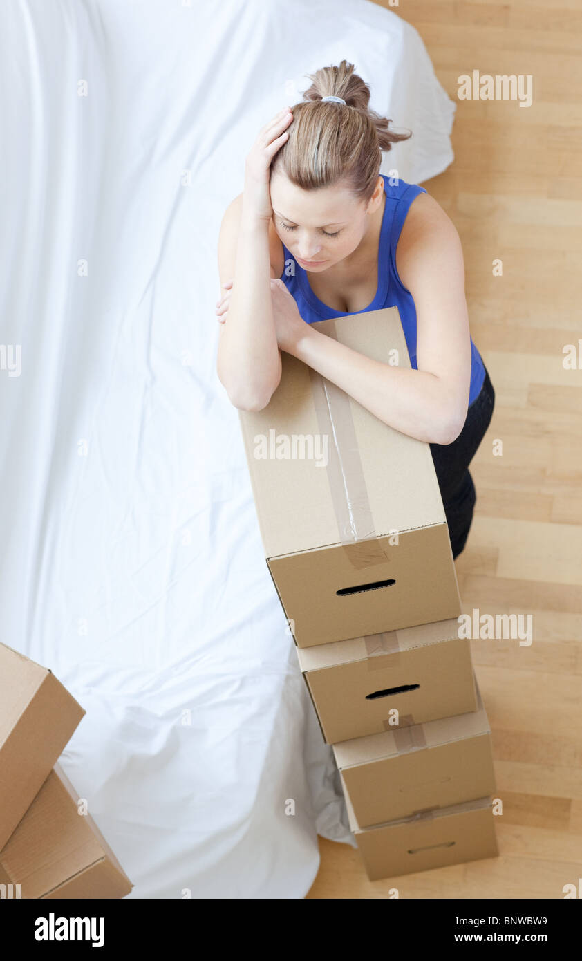 Tired woman is moving various boxes Stock Photo - Alamy