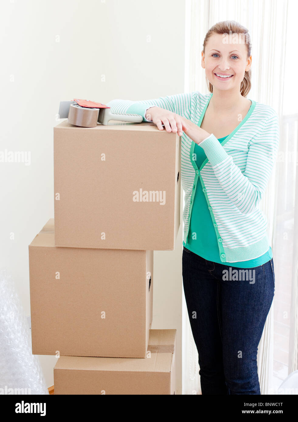 Beautiful woman closing various boxes Stock Photo - Alamy