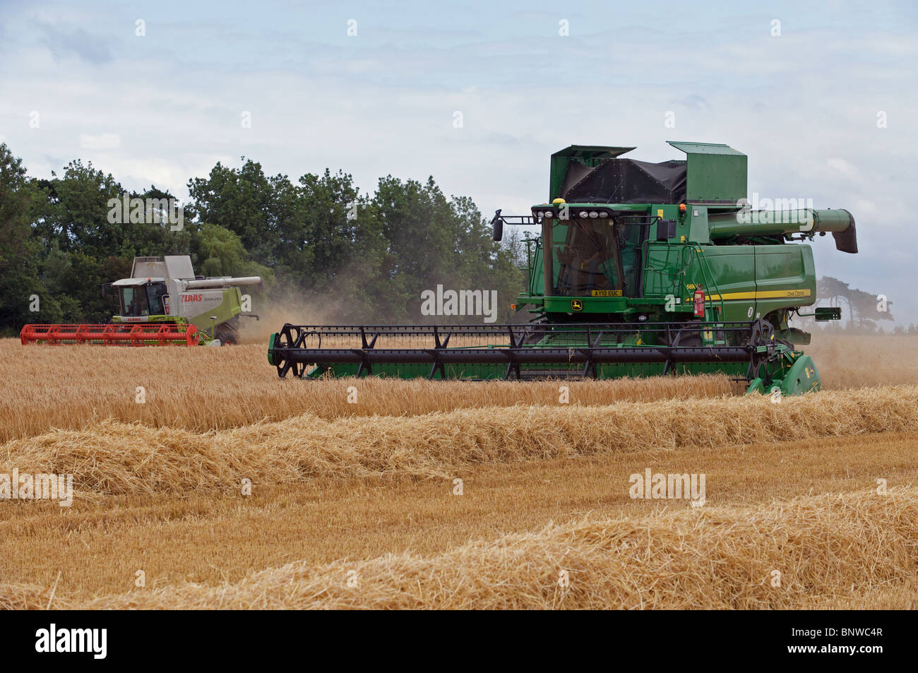 John Deere S690i and Claas Lexion 570 combine harvester working in ...
