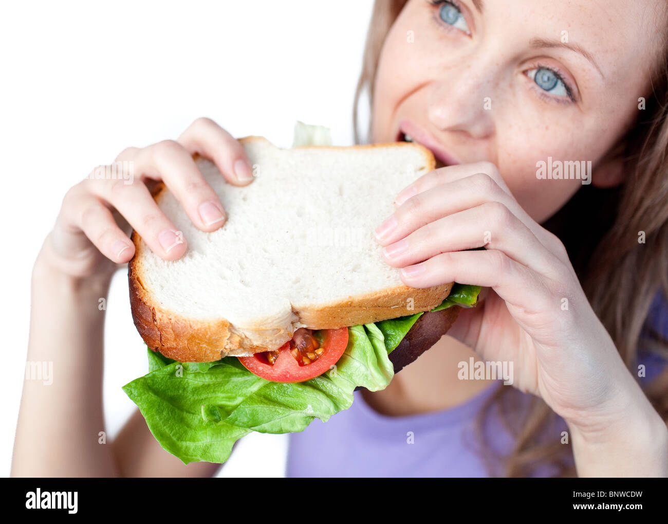 Hungry woman holding a sandwich Stock Photo - Alamy