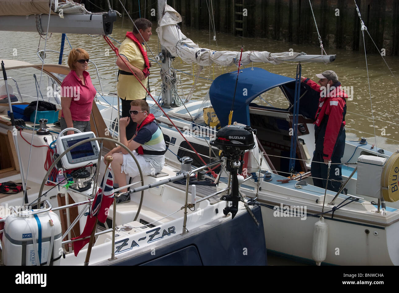 tied double berthed sailing boat sailors talking Stock Photo - Alamy