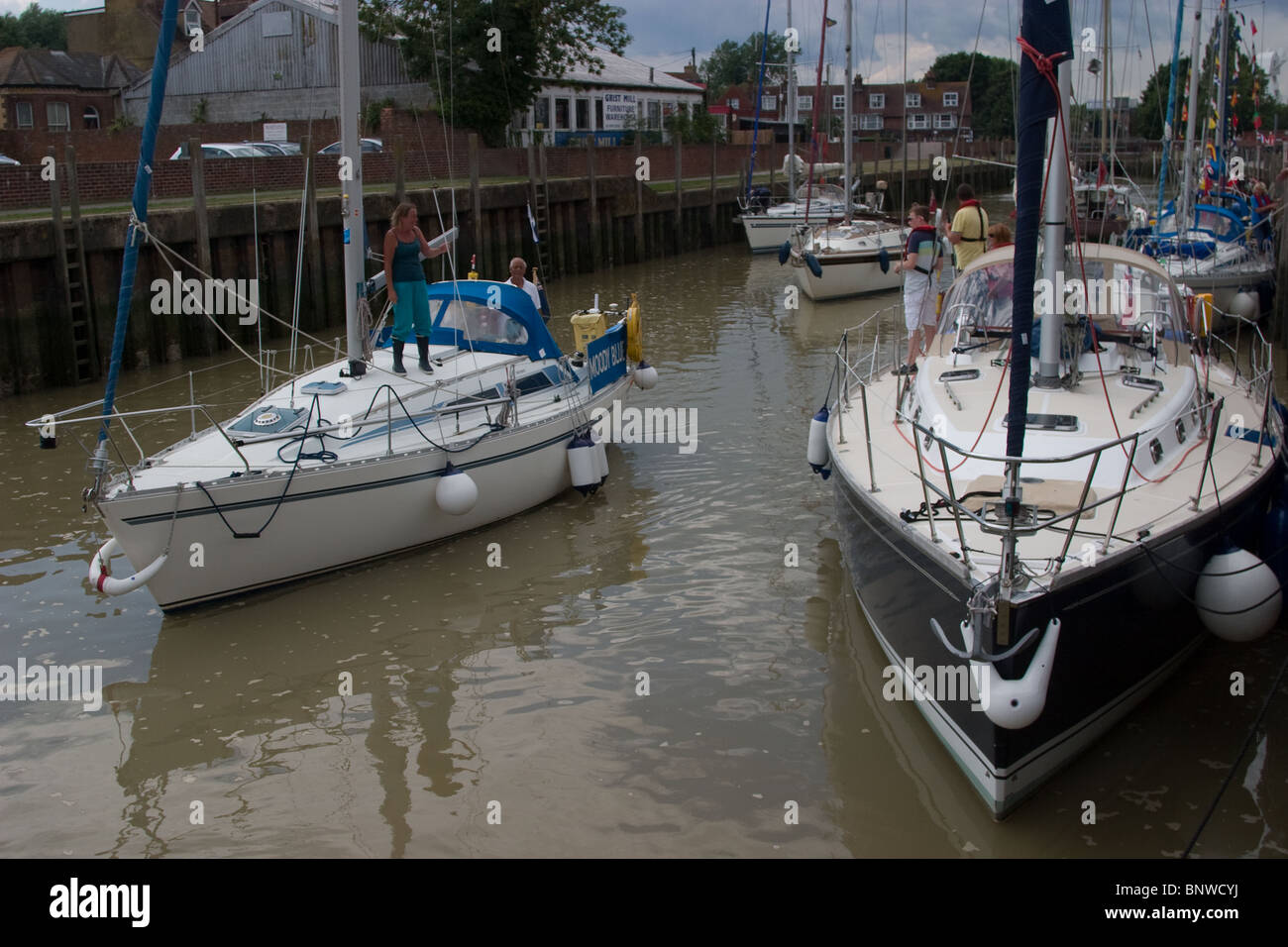 tied sail sailing boat casting off sailor mooring Stock Photo - Alamy