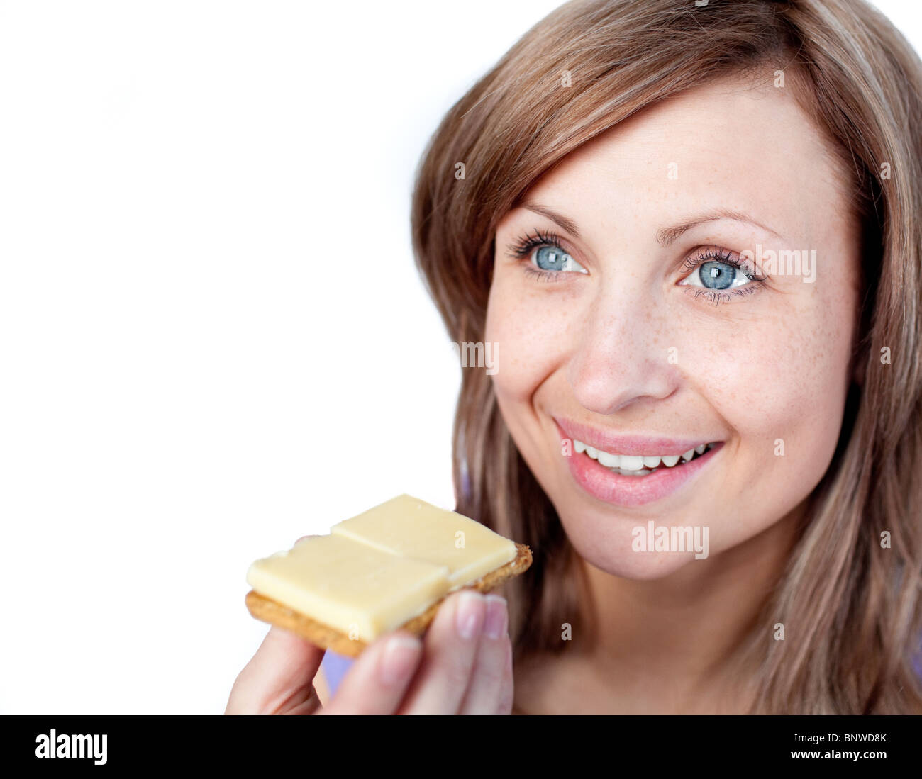 Cute woman eating a cracker with cheese Stock Photo - Alamy
