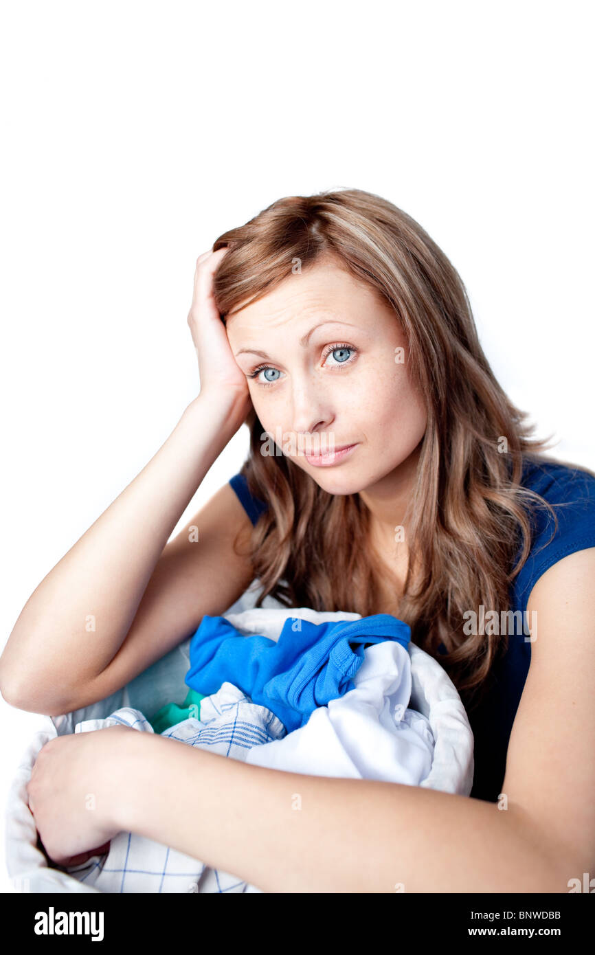 Unhappy woman doing laundry Stock Photo - Alamy