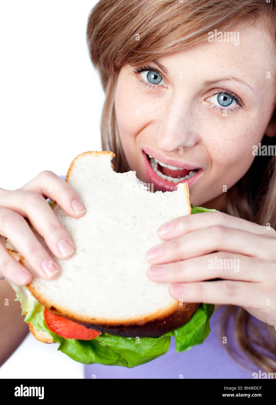 Blond woman eating a sandwich Stock Photo - Alamy
