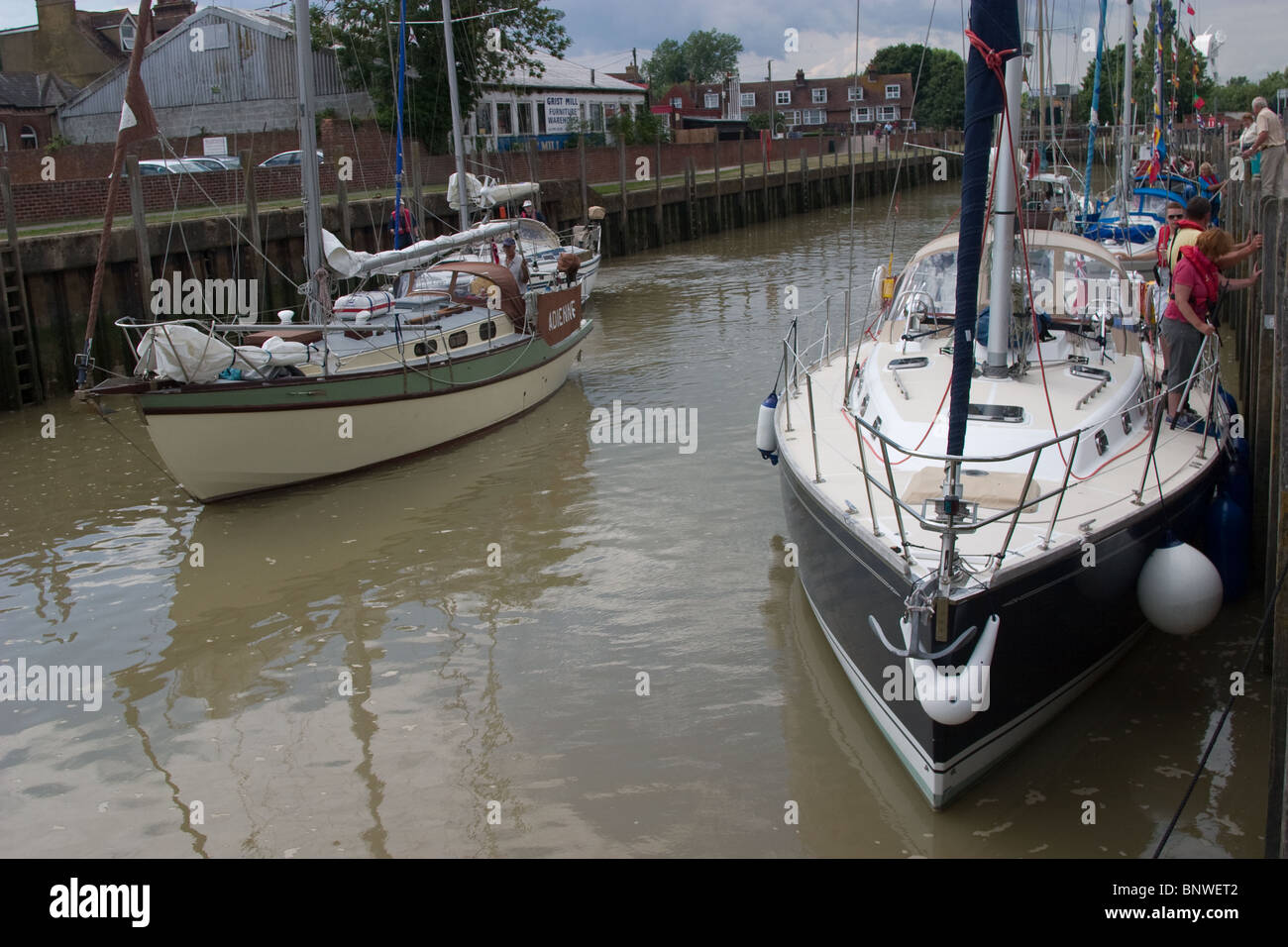 tied sail sailing boat casting off sailor mooring Stock Photo - Alamy
