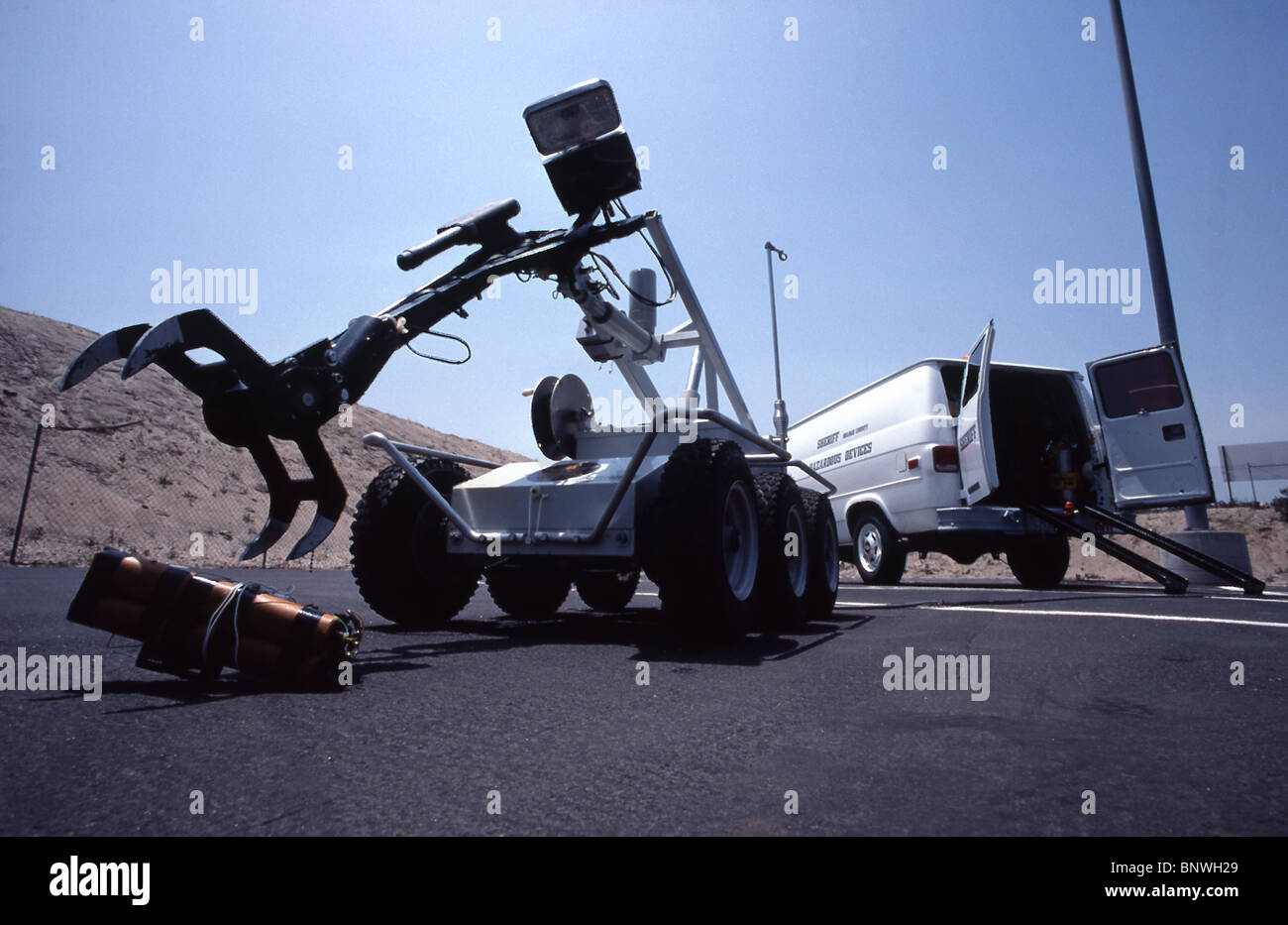 Remote-controlled robot reaches for an illegal explosive device in ...