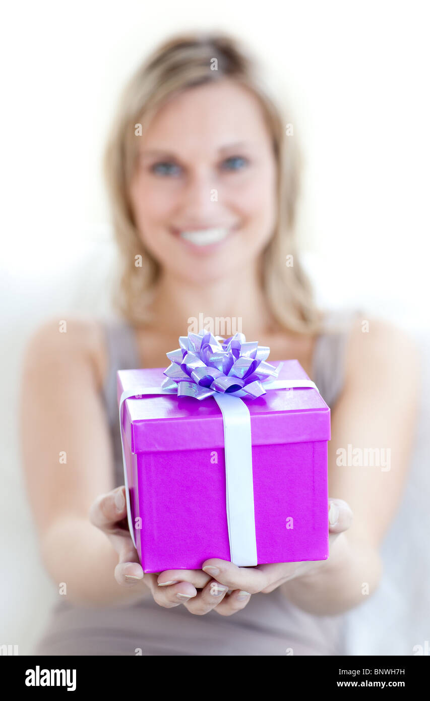A charming woman is holding a present Stock Photo - Alamy