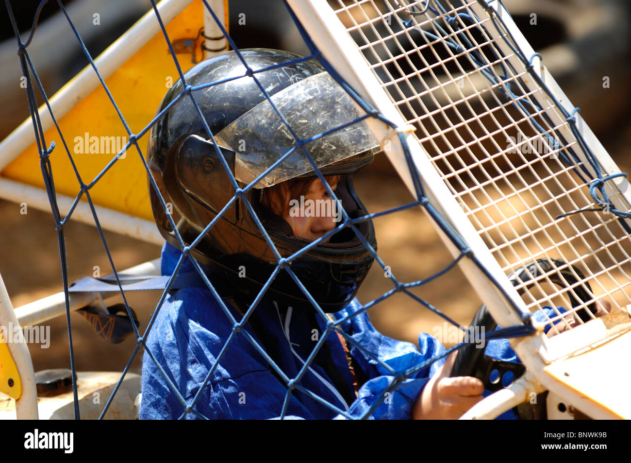 Teenage Boy in Racing Suit sitting in a Off Road Racer Stock Photo - Alamy