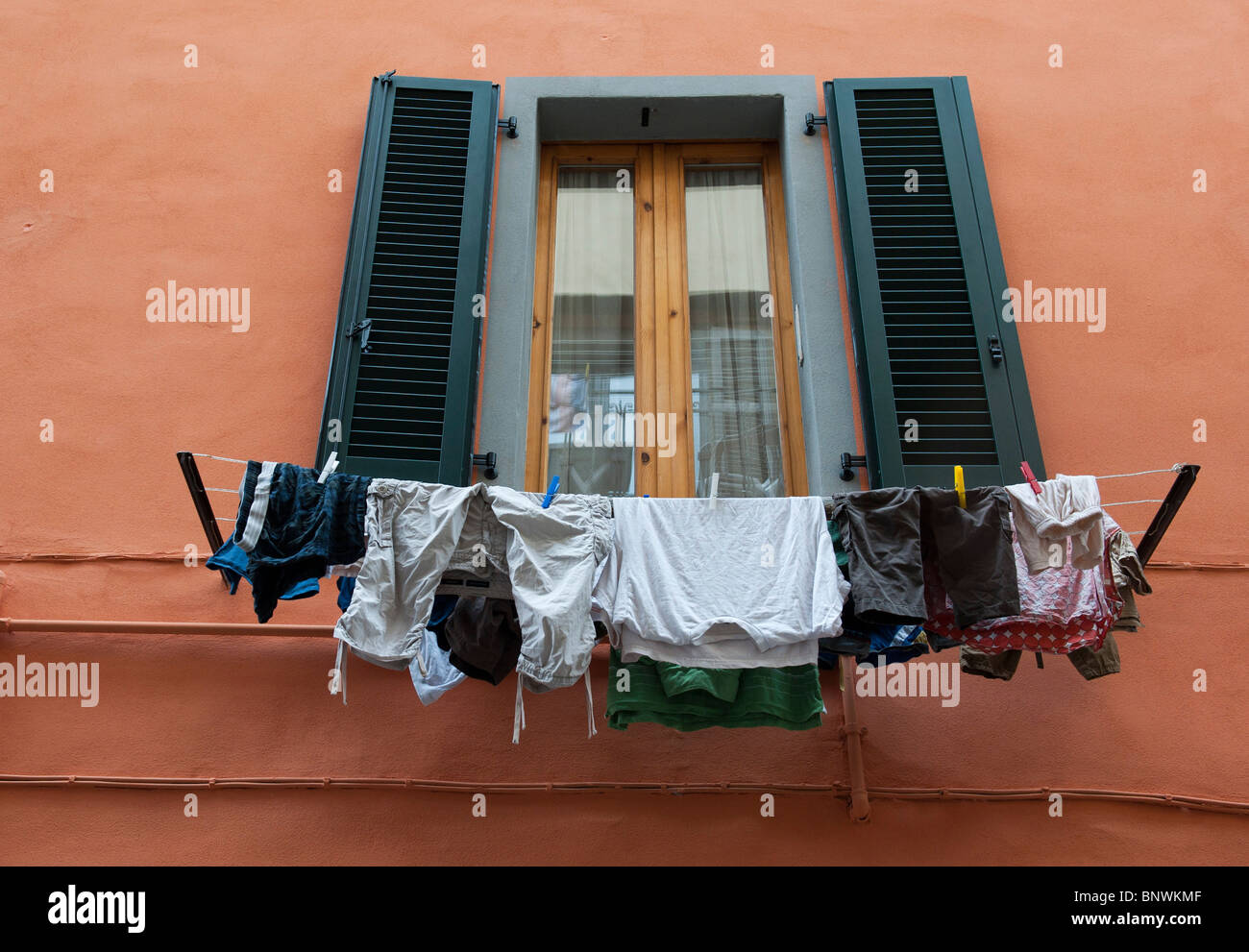 Clothes on washing line outside window Stock Photo - Alamy
