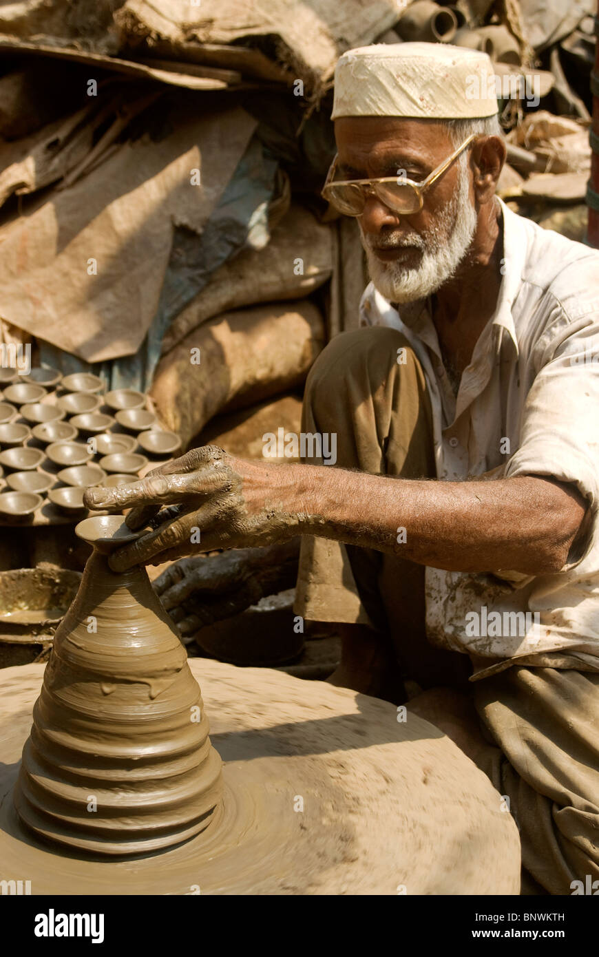Indian Potter crafting earthen pots using traditional methods ...